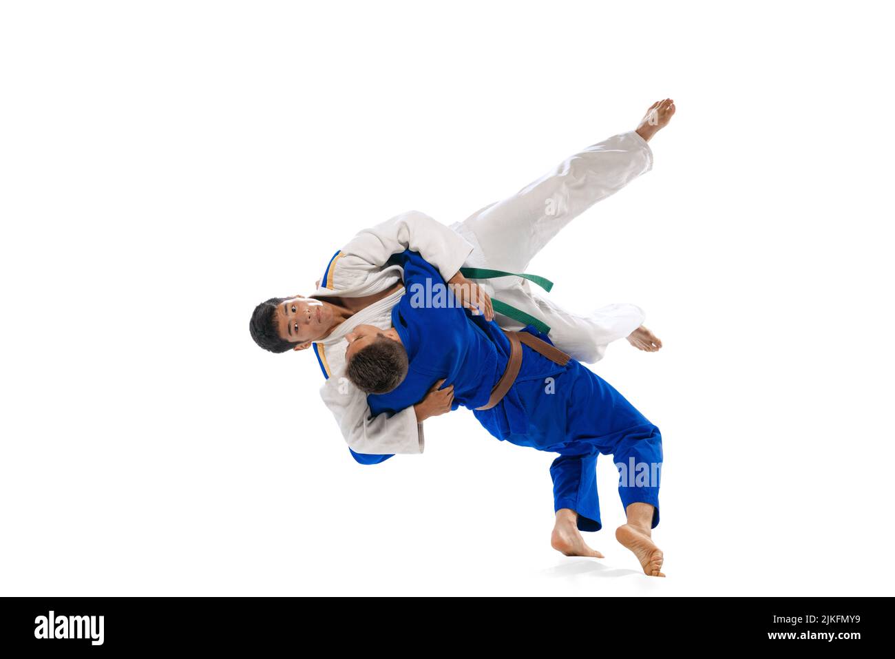 Studio shot of two men, professional judo athletes training isolated ...