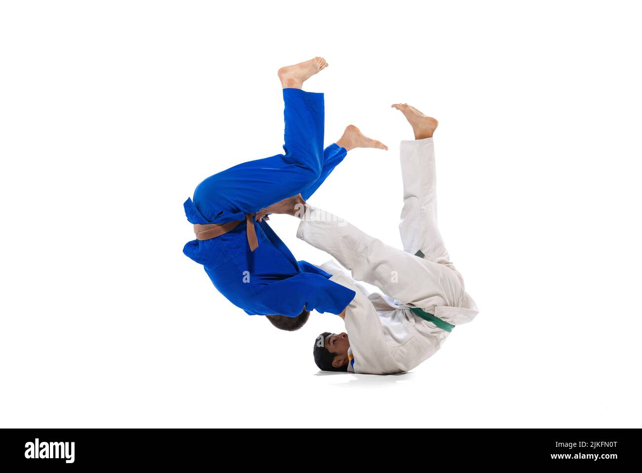 Studio shot of two men, professional judo athletes training isolated ...