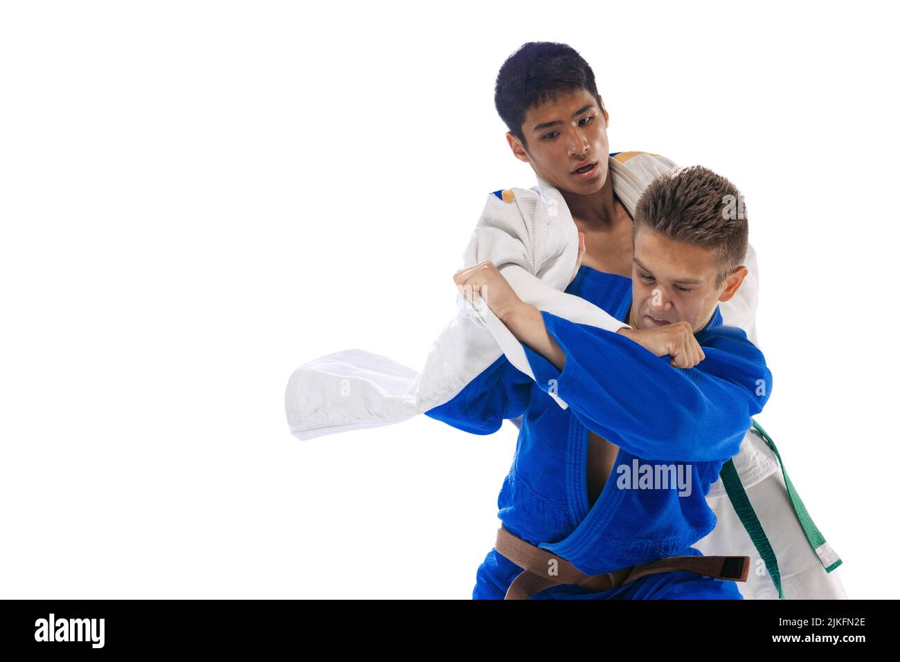 Dynamic portrait of two young men, professional judo athletes training ...