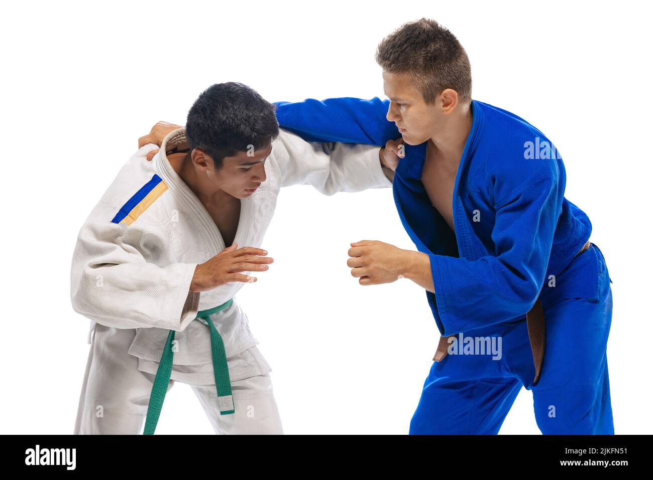 Studio shot of two men, professional judo athletes training isolated ...