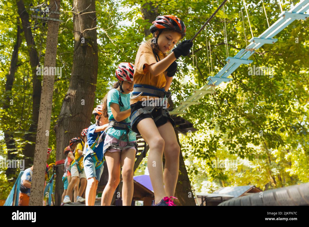 The children are overcoming obstacles in the rope park Stock Photo - Alamy