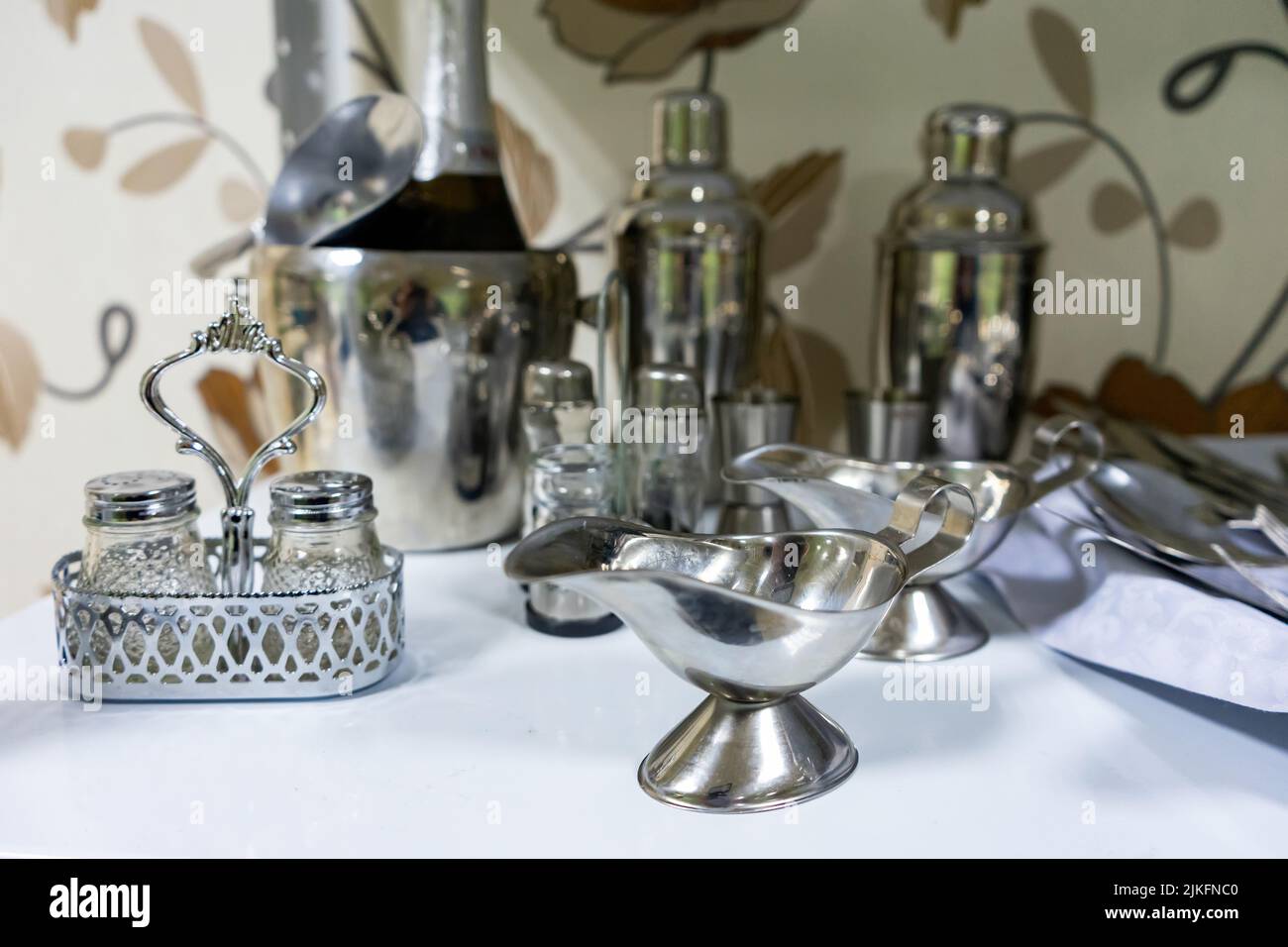 A set of various cutlery and objects. A variety of shiny metal cutlery ...