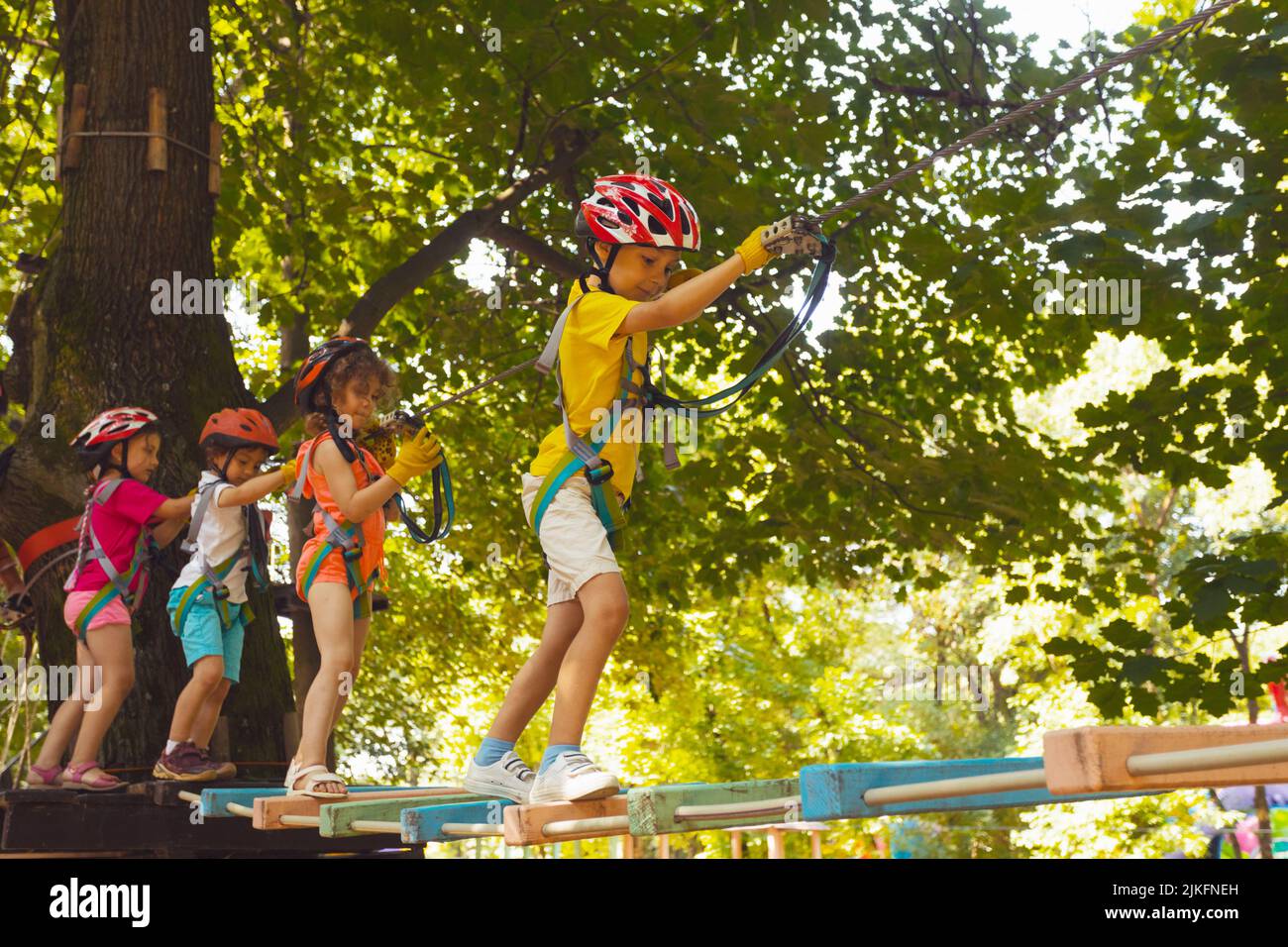 The kids are climbing on the suspension bridge Stock Photo - Alamy