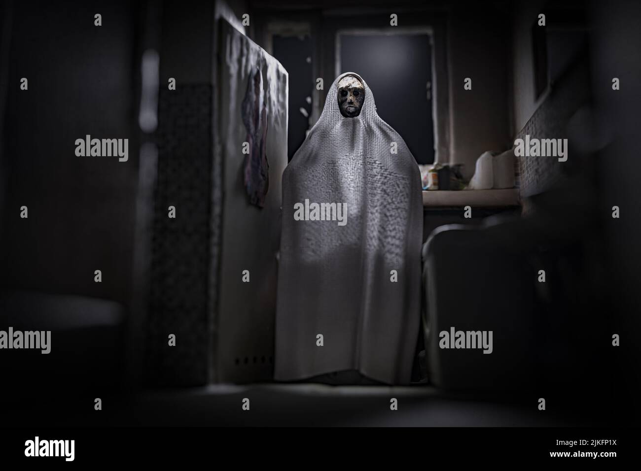 A demon with a skull face is standing at the open door. Horror ...