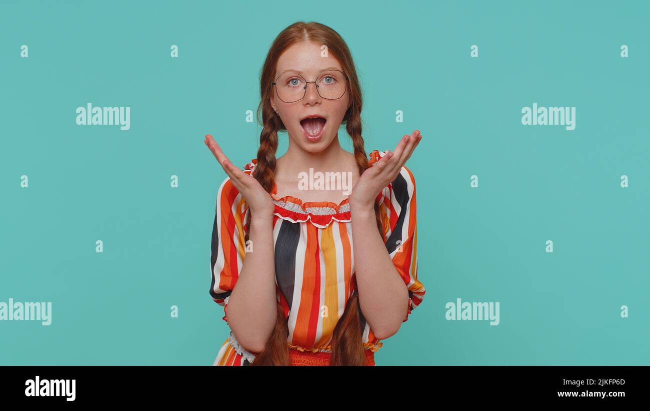 Oh my God, Wow. Excited amazed winner ginger girl raising hands in ...