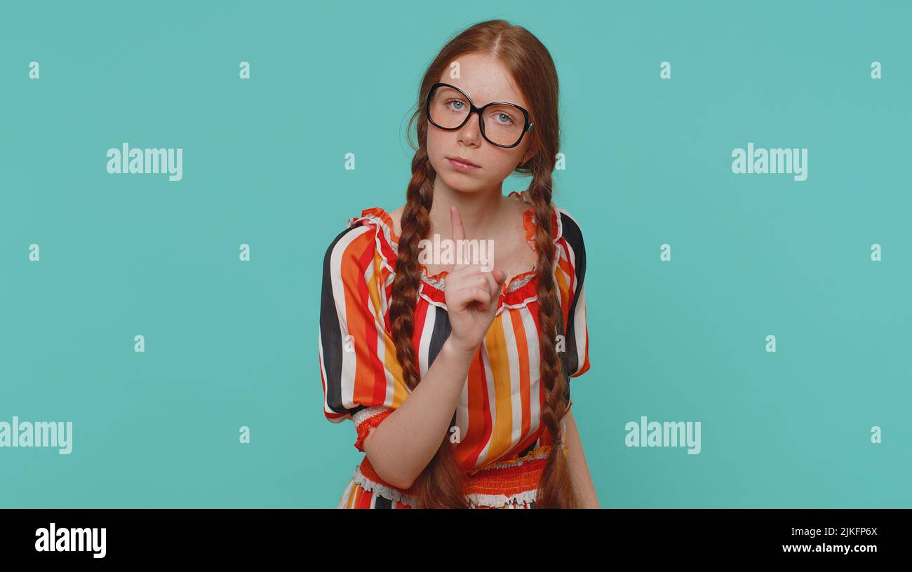 Displeased girl shakes finger and saying no, be careful, scolding and ...