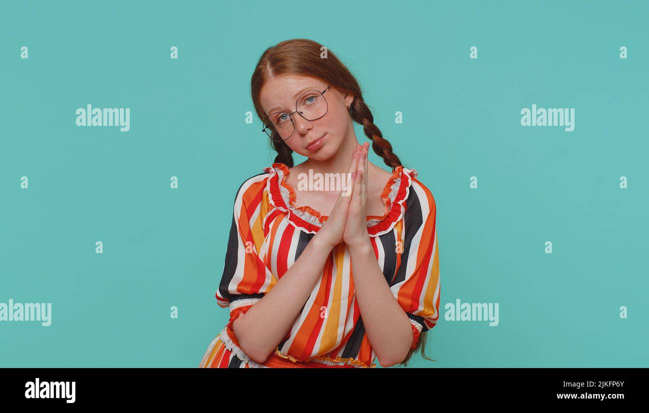 Please, God help me. Redhead girl praying, looking upward and making ...