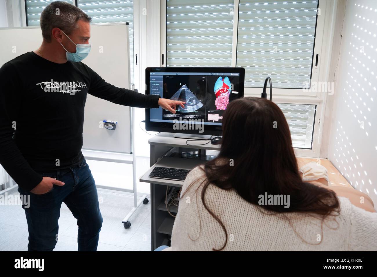 Students and their teacher during an echography simulation workshop on ...