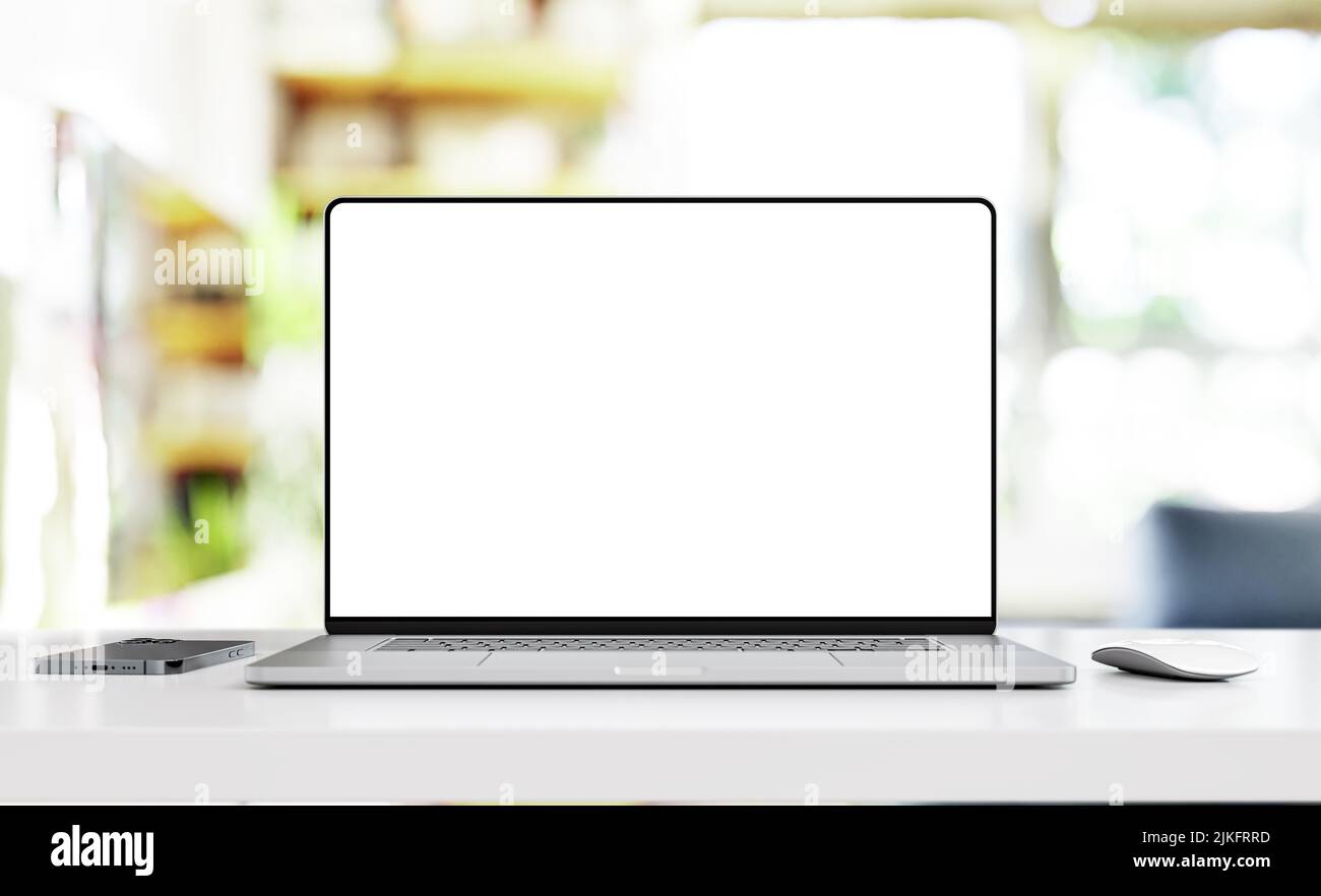 Laptop with frameless blank screen on table in home interior Stock ...