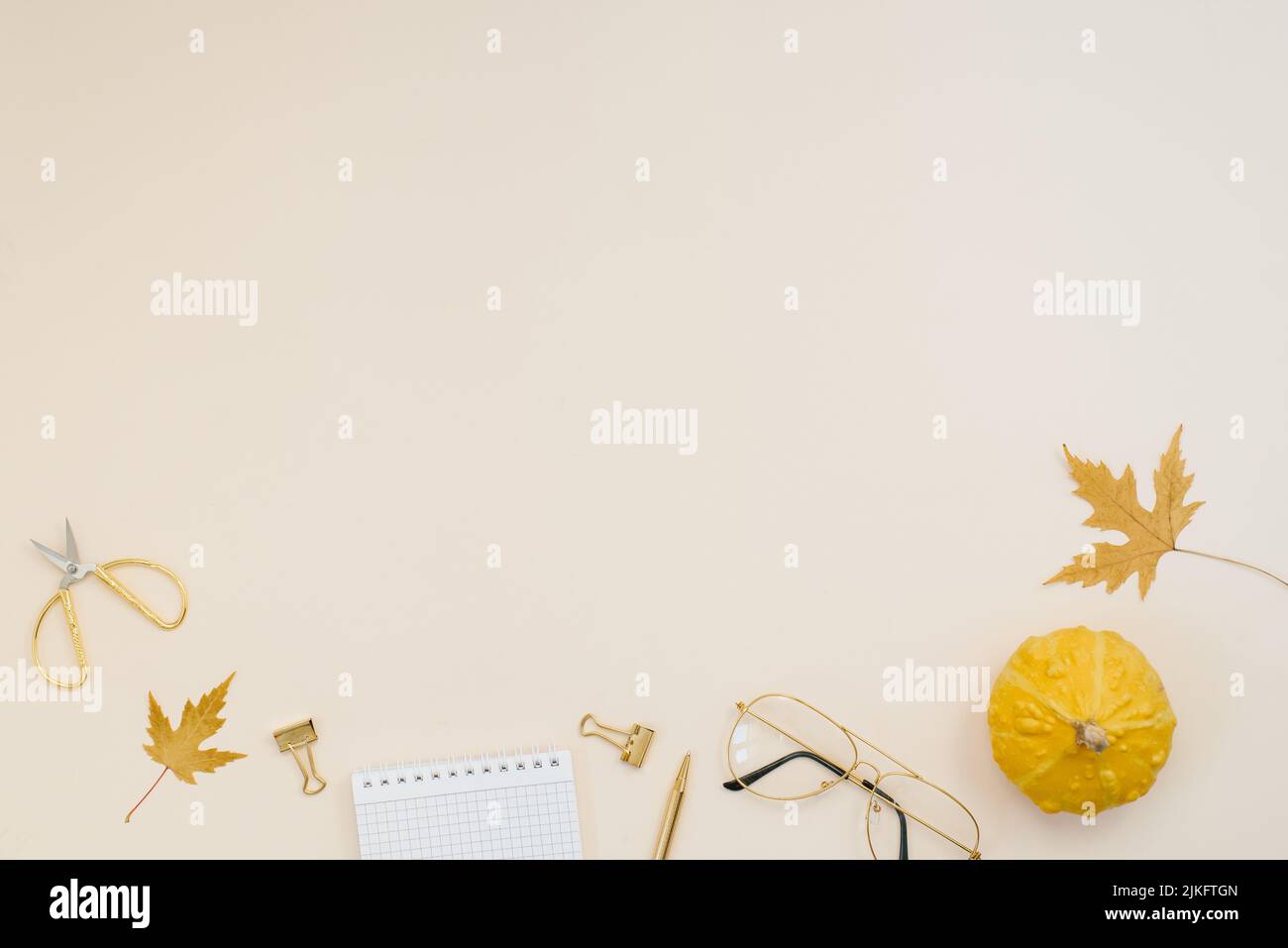 Workplace computer with yellow maple leaves and pumpkins, scissors ...