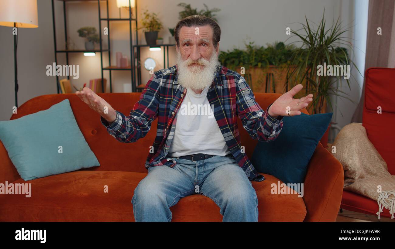 What. Why. Senior old grandfather raising hands in indignant expression ...