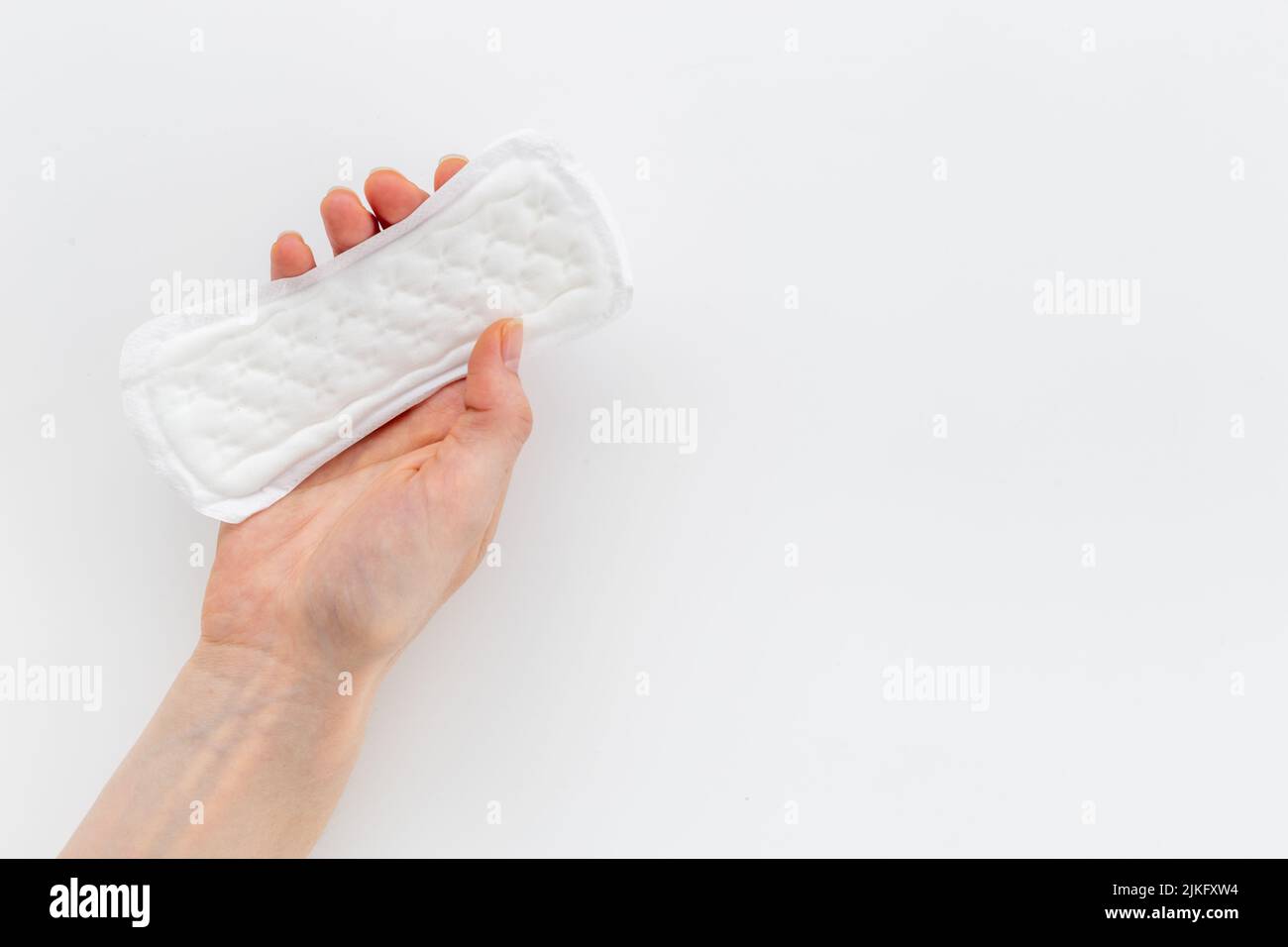 White pad in female hand. Menstruation period and daily hygiene concept ...