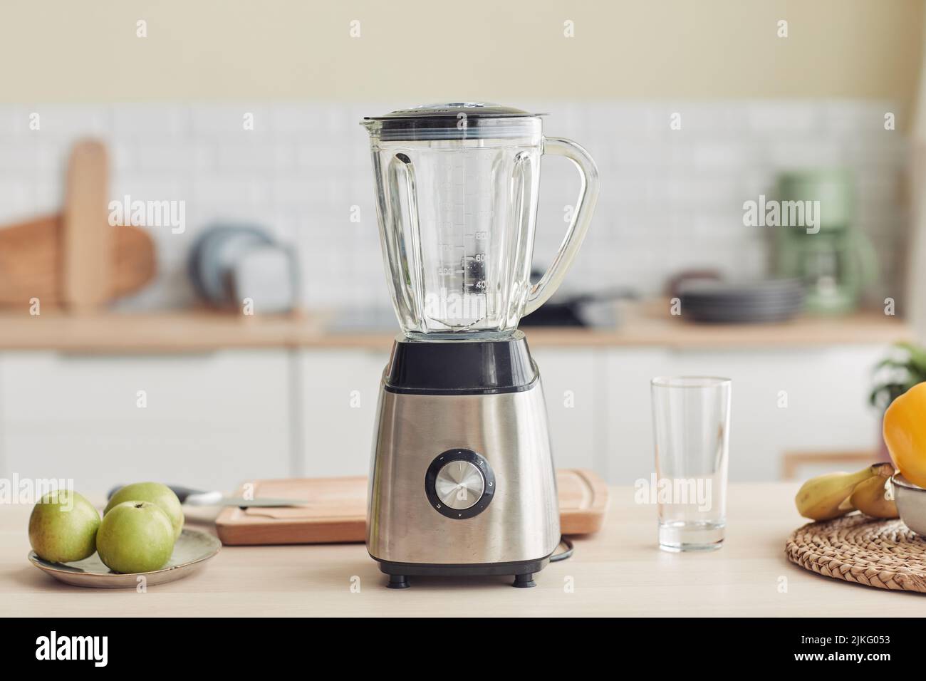 Background image of chrome blender on kitchen counter with fruits, copy ...