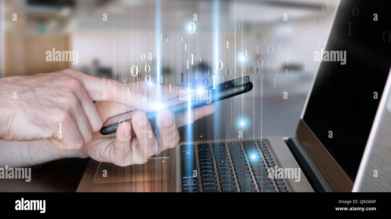 hand on smartphone before laptop. mixed media web binary codes ...