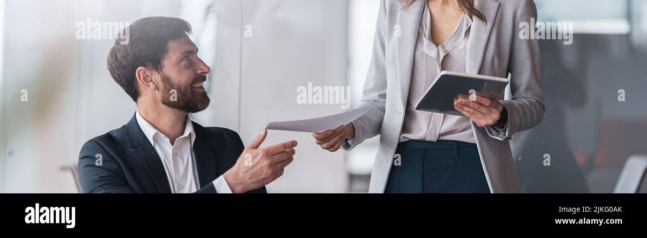 Smiling secretary brought the documents to the boss to sign Stock Photo ...