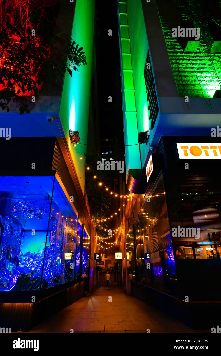 A vertical shot of an alley between restaurants at night in Sydney CBD ...