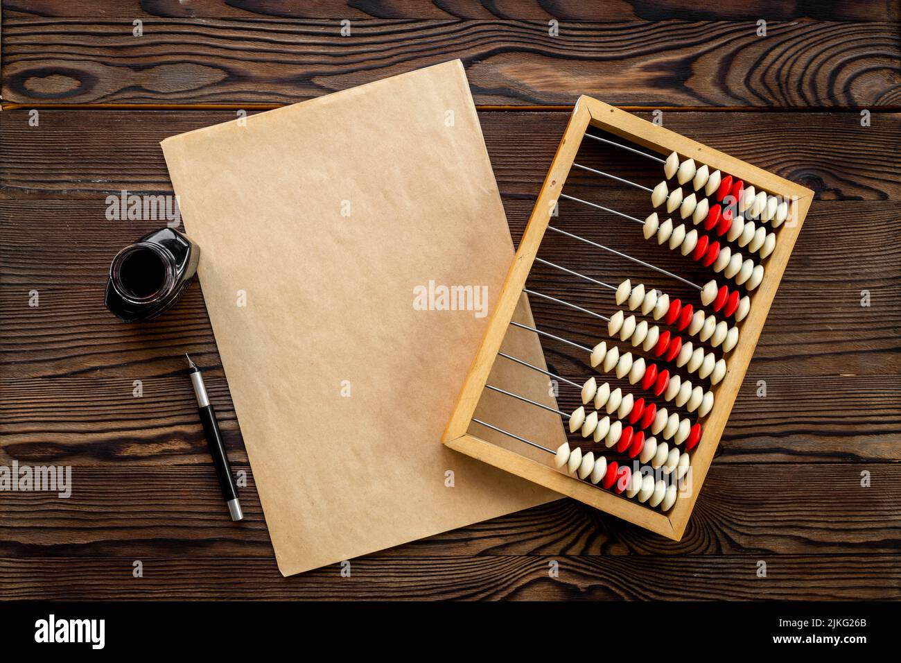 Accounting wooden abacus with blank sheet of paper. Financial ...