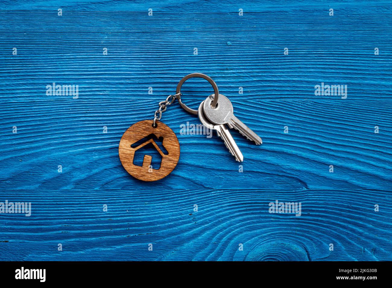 House shaped keychain and keys. Sale or rent real estate concept Stock ...