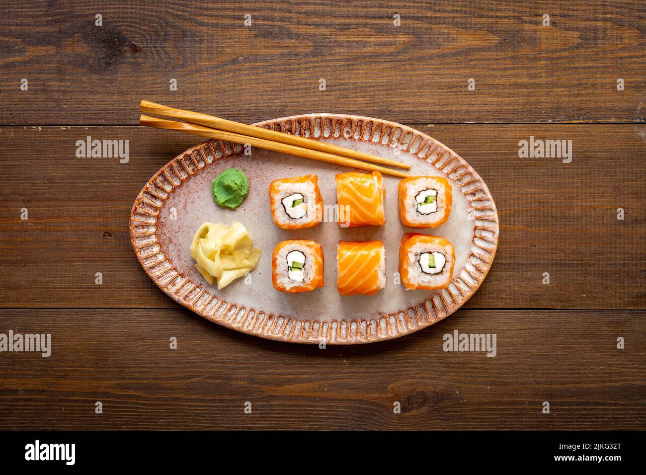 Japanese cuisine. Salmon sushi rolls set on plate, top view Stock Photo ...