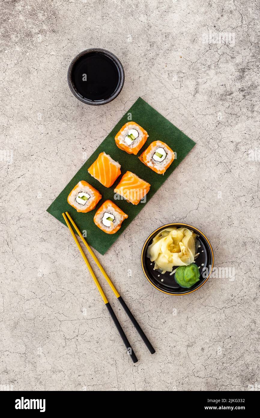 Japanese cuisine. Salmon sushi rolls on eco green papper plate Stock ...