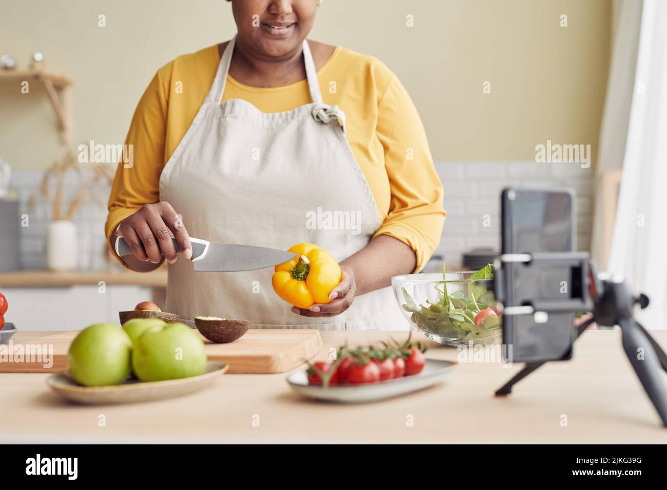 Closeup of young black woman cooking healthy meal in kitchen and ...