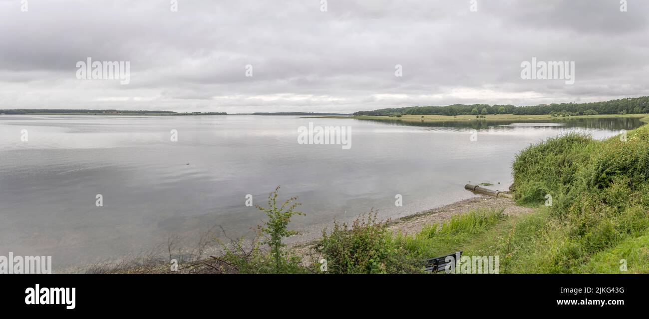 fjord landscape with flat waters and green shores, shot under bright ...