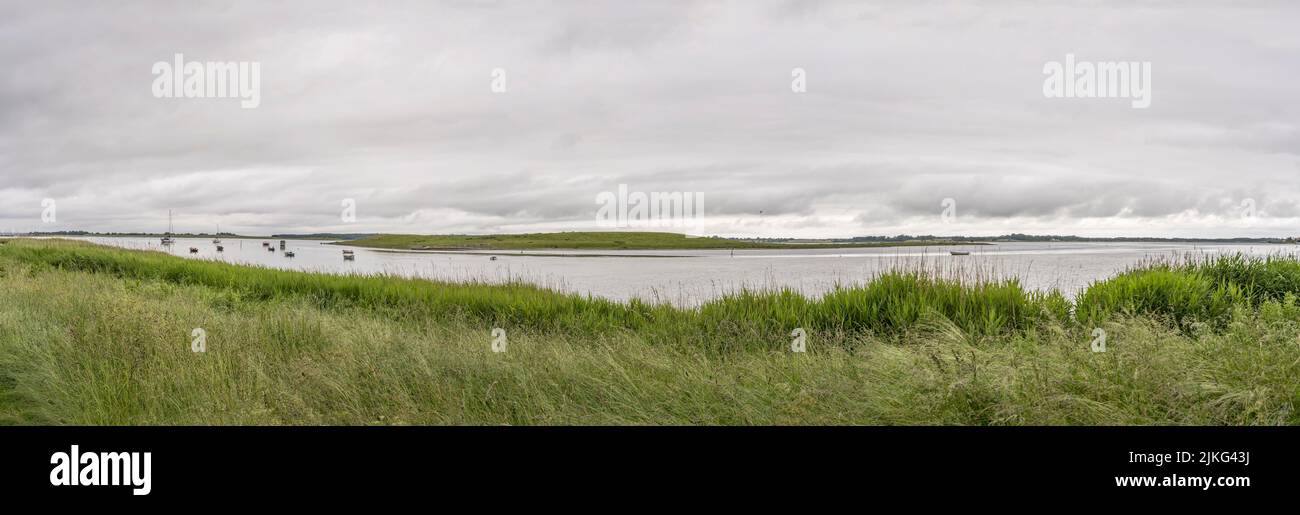 boats moored in fjord landscape with flat waters and green shores, shot ...