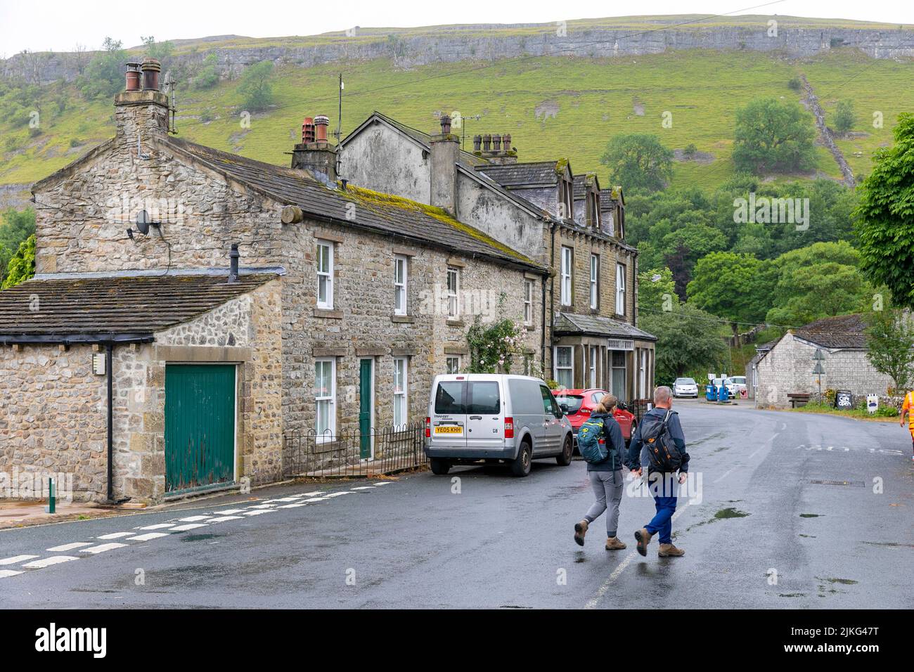 Kettlewell village in the Yorkshire Dales, two adults walking and ...