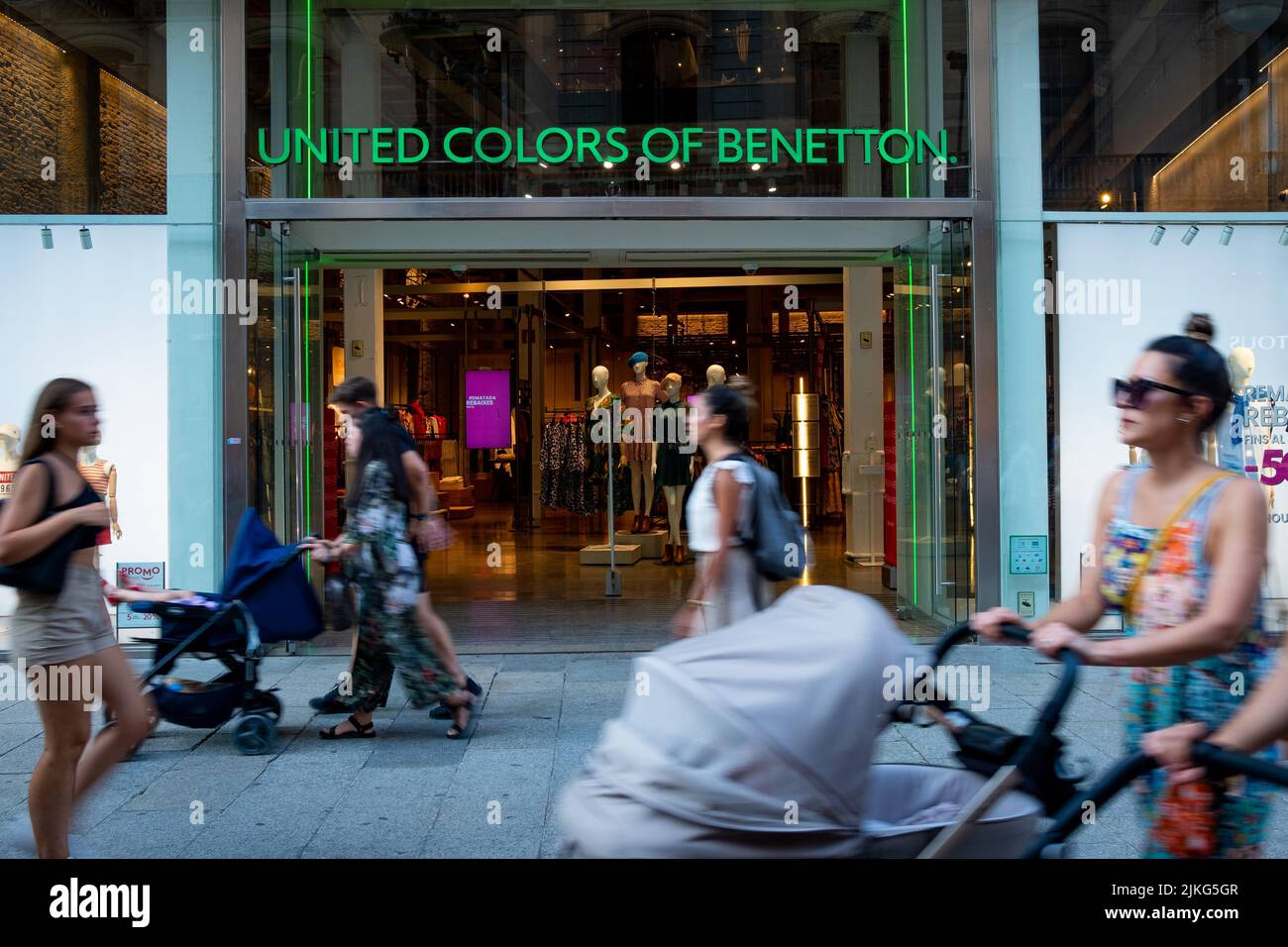 Shoppers and tourists are seen passing by a Benetton store in the city ...