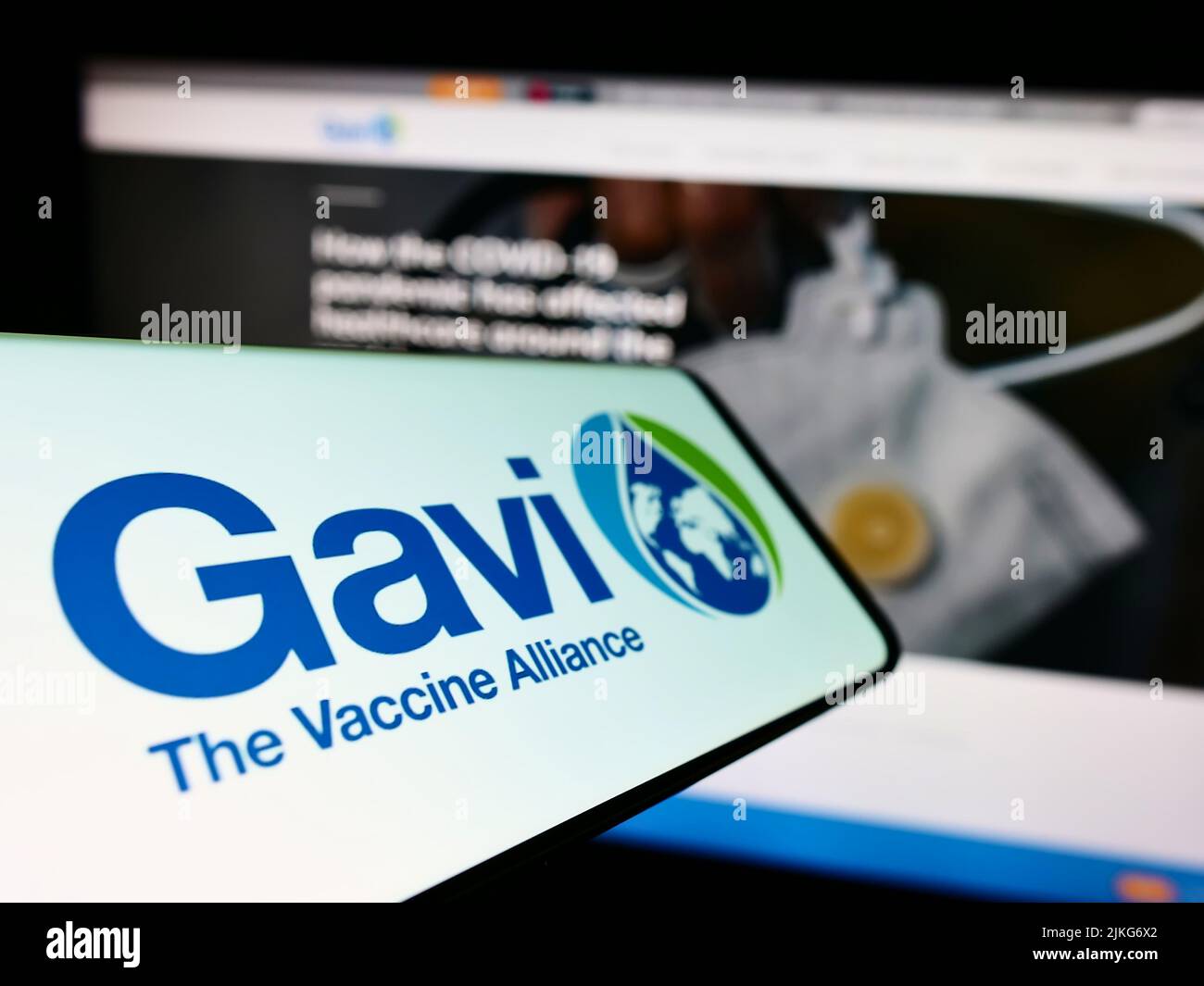 Mobile phone with logo of health partnership Gavi, the Vaccine Alliance ...
