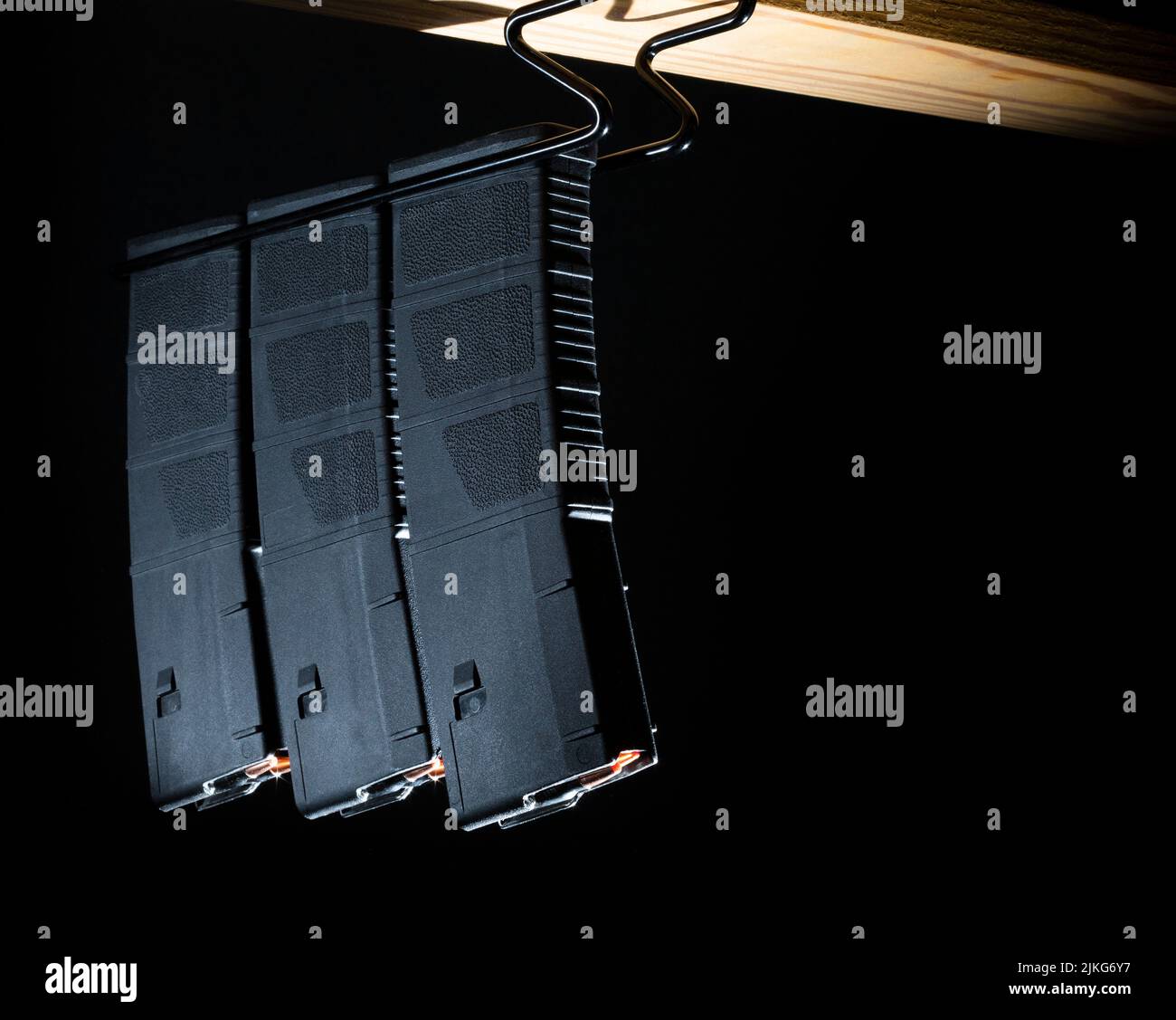 AR-15 magazines loaded with ammunition on a hanger with a black ...