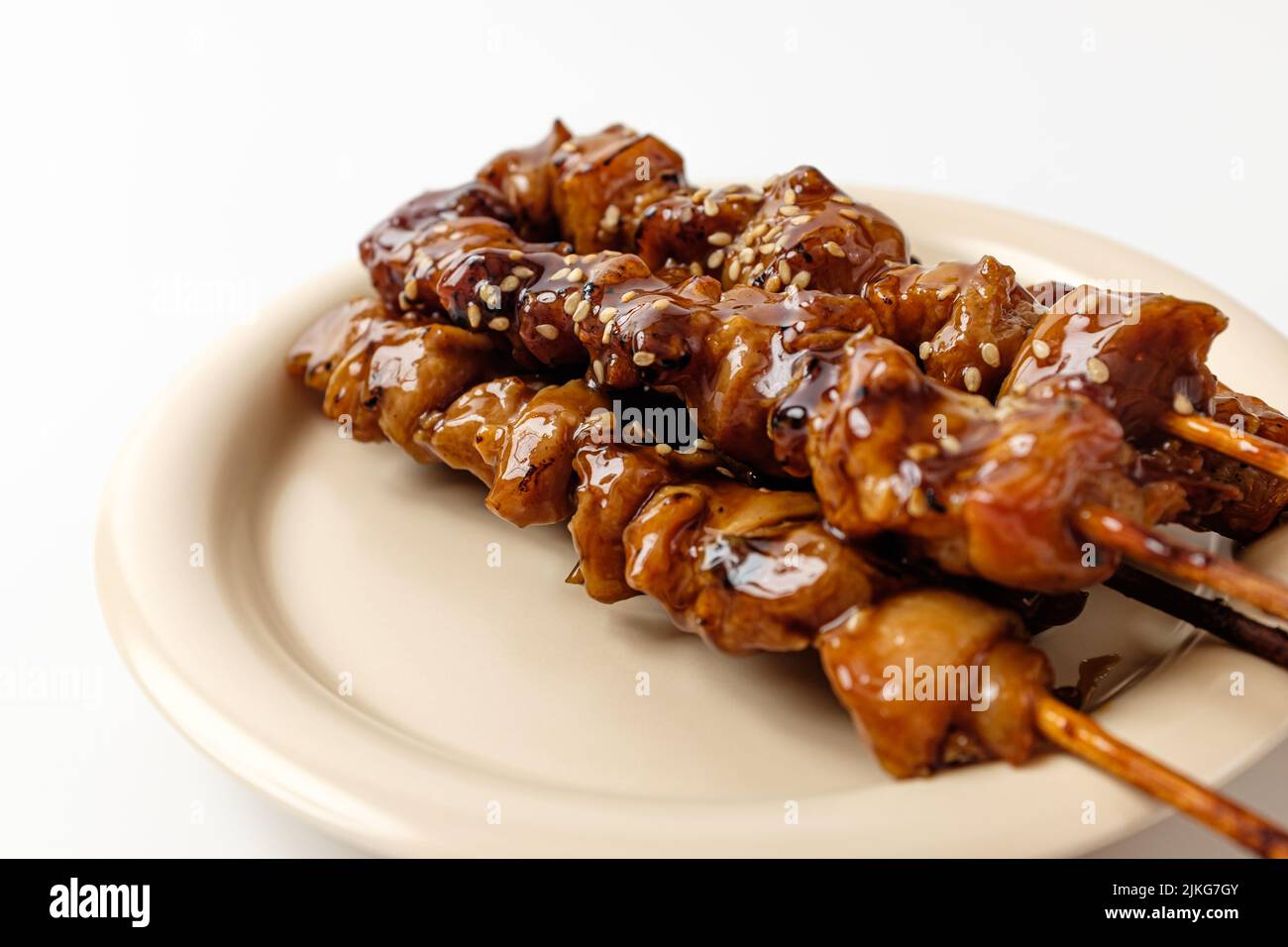 Teriyaki chicken skewers on a white background Stock Photo - Alamy