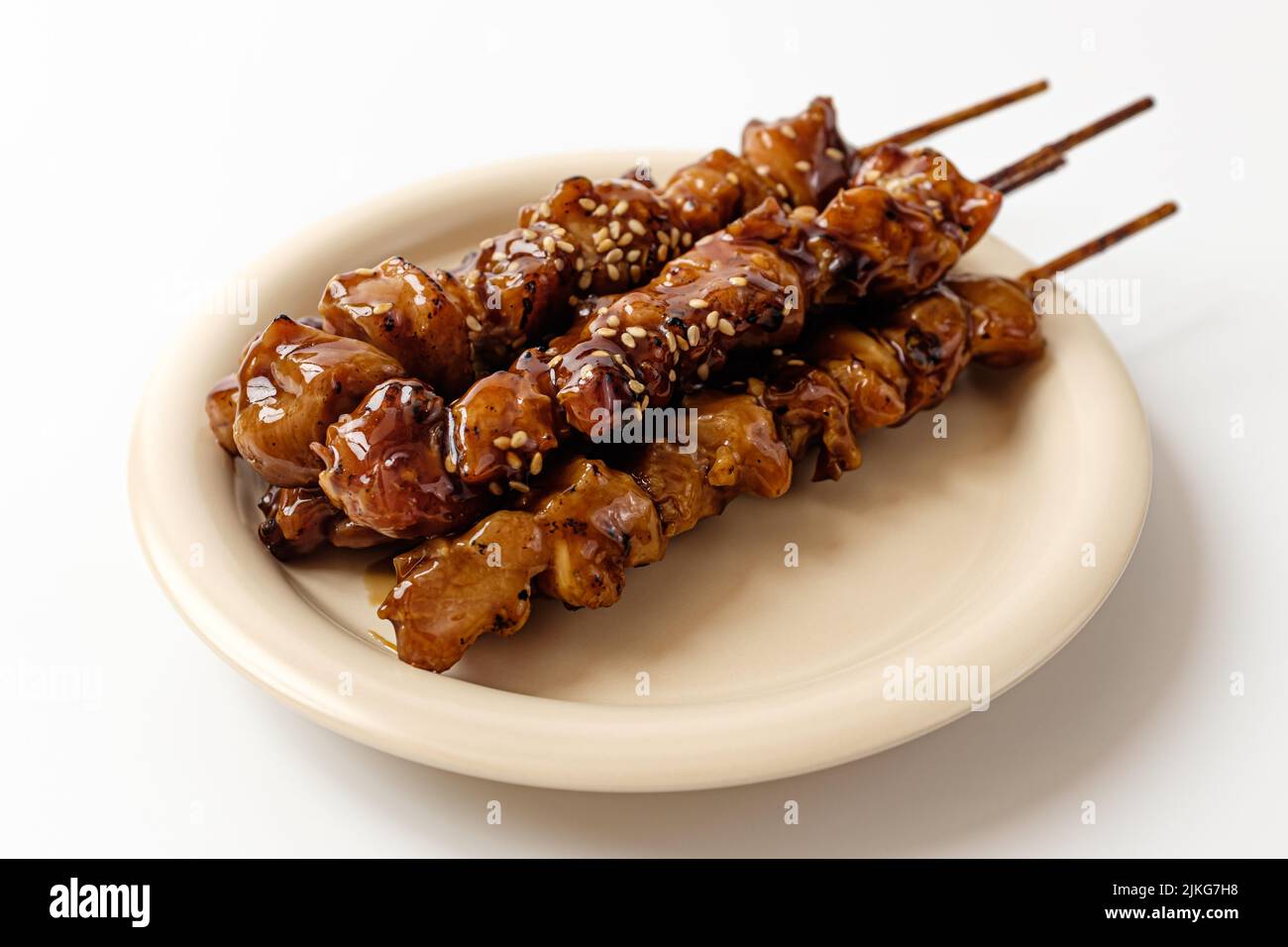 Teriyaki chicken skewers on a white background Stock Photo - Alamy