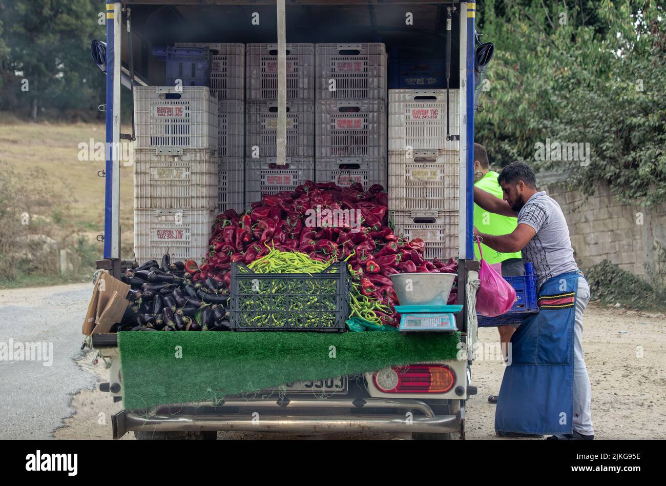 Groceries street seller trade from his truck, full of capia and green ...