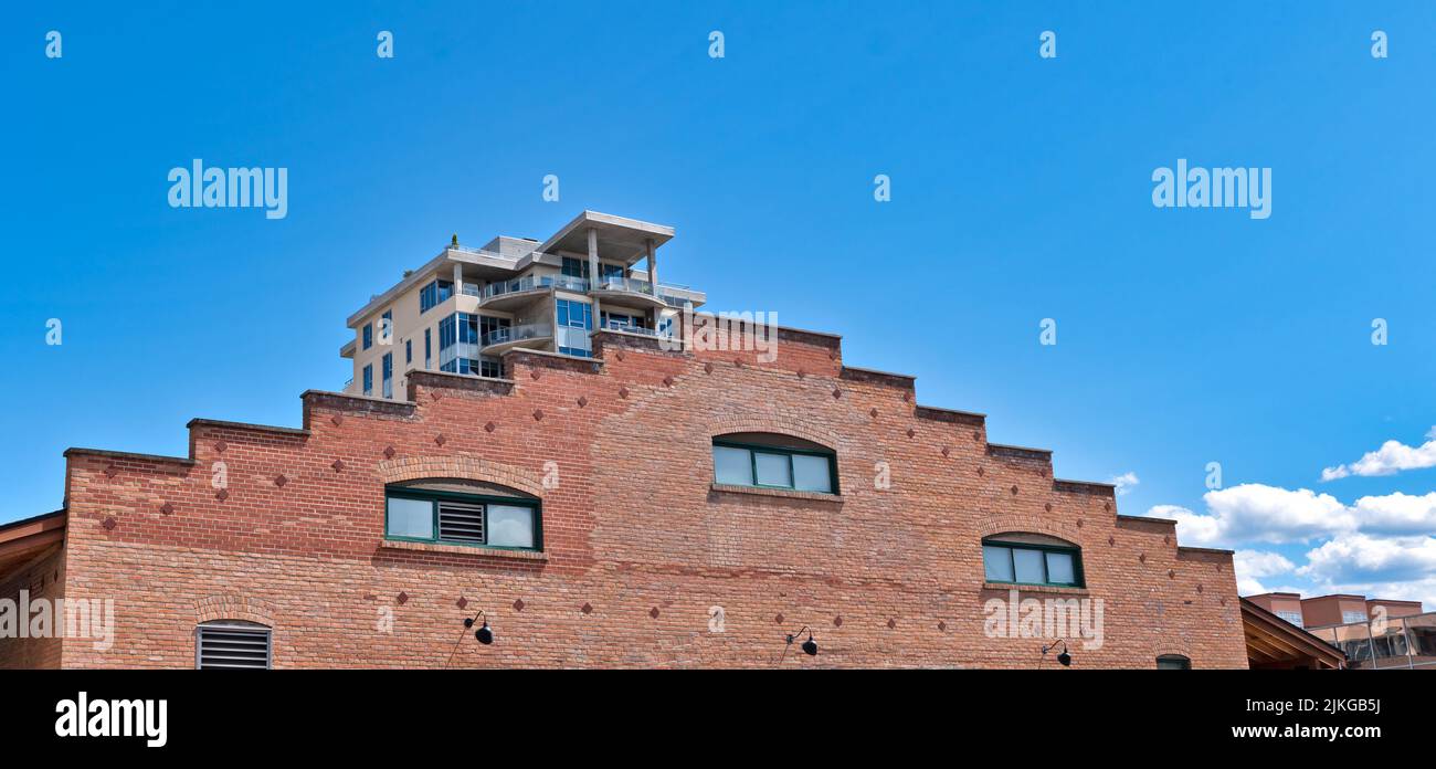 Brick wall of historic building with modern building on the back Stock ...
