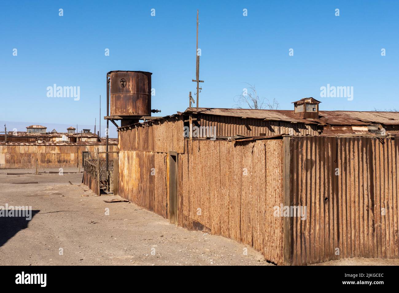 A rusty old water tank on a workshop building in the outdoor museum of ...