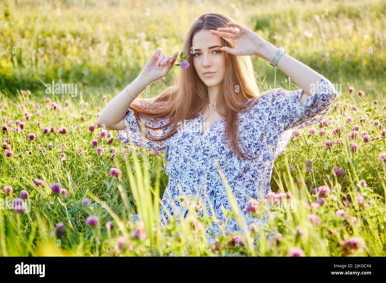 young beautiful girl with a bouquet of flowers in nature Stock Photo ...