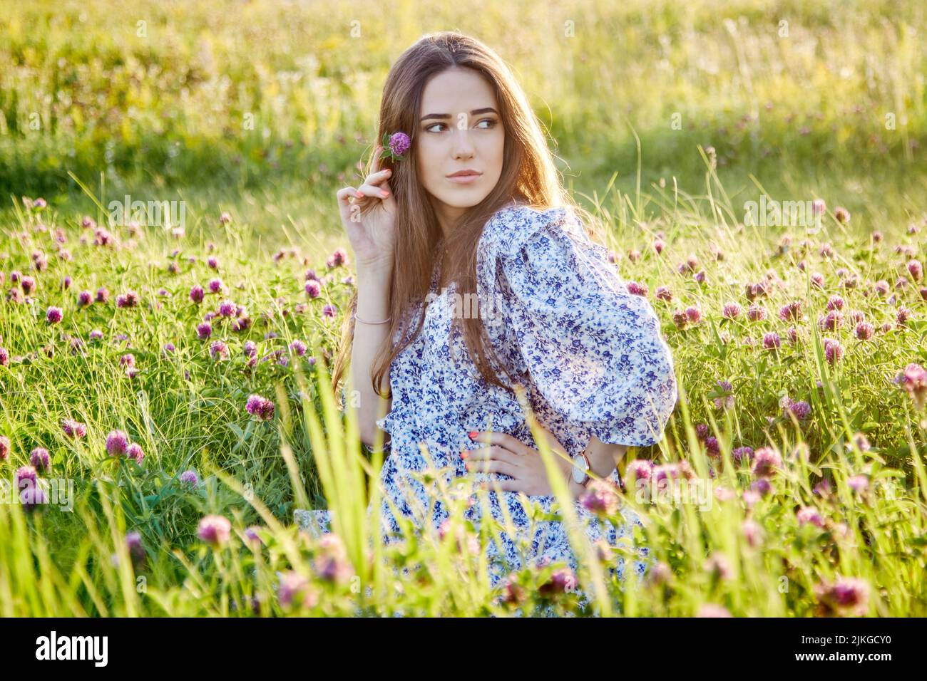 young beautiful girl with a bouquet of flowers in nature Stock Photo ...