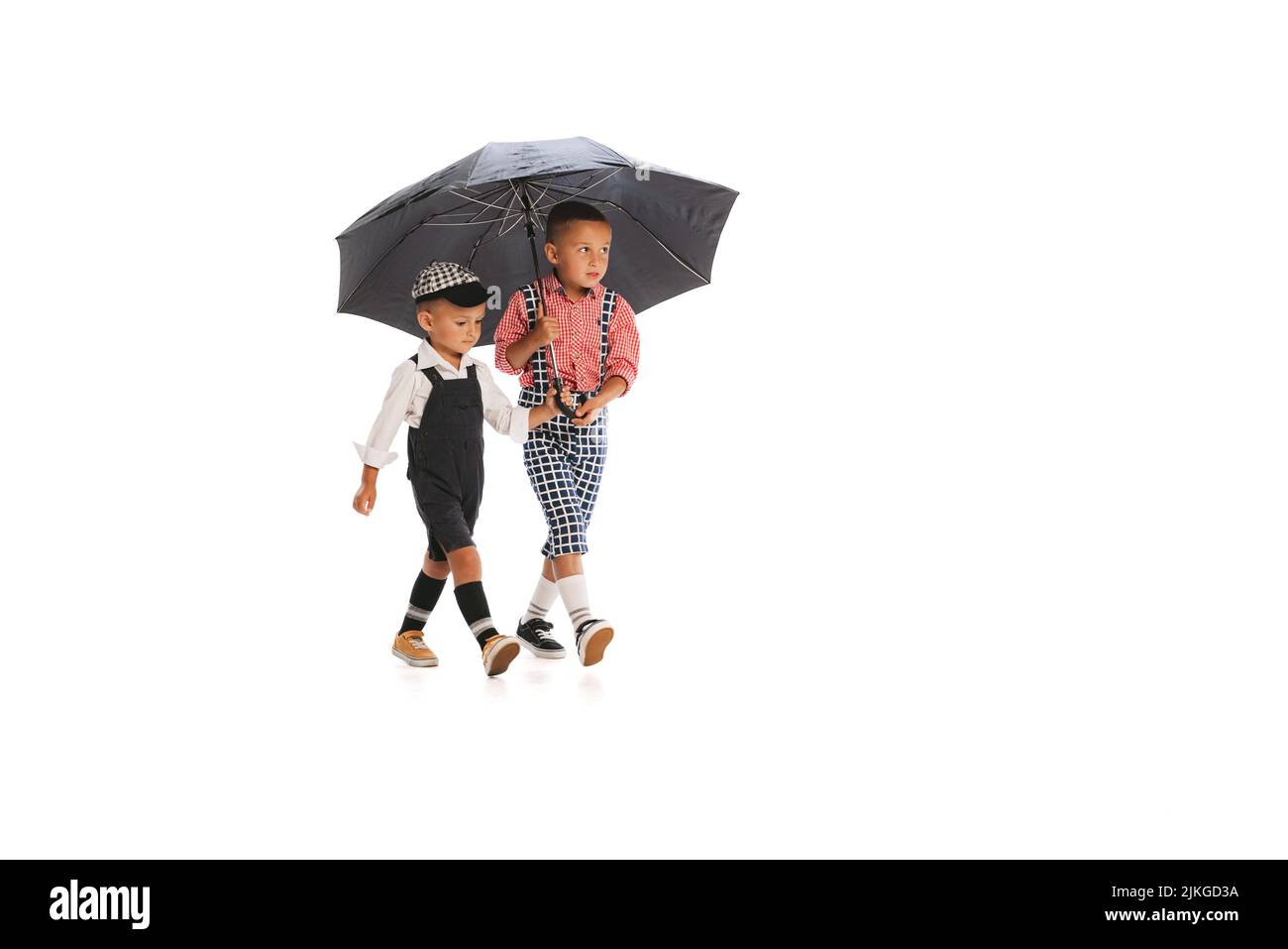 Portrait of two little boys, children in stylish vintage outfit walking ...