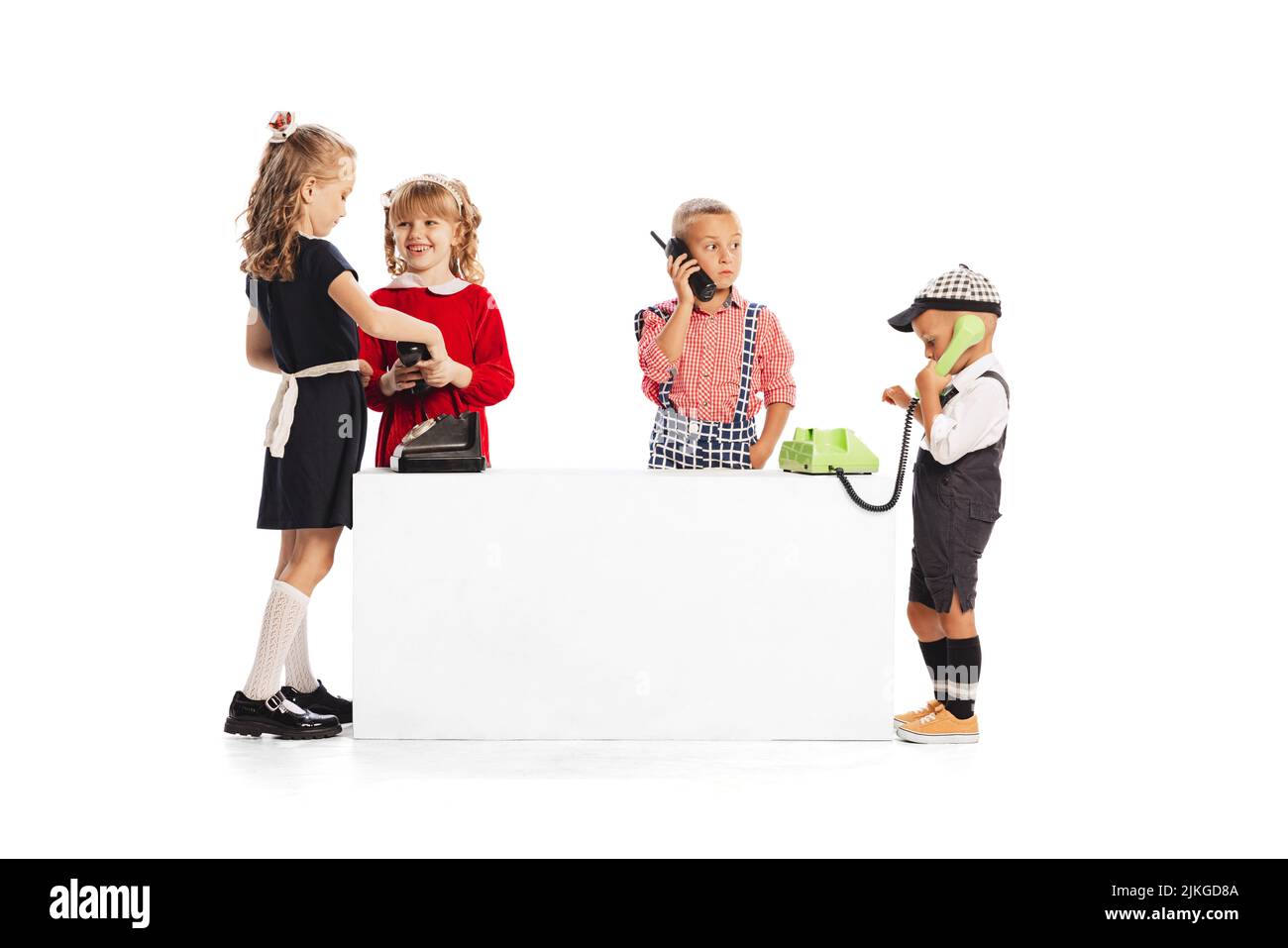 Portrait of stylish children in retro clothes posing, talking on retro ...