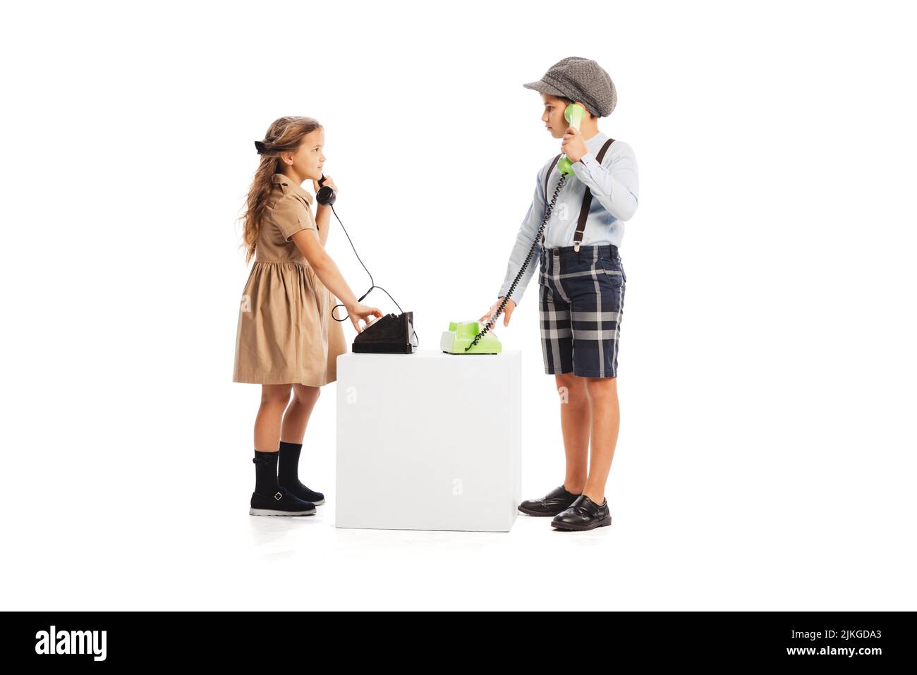 Portrait of two stylish children in vintage clothes playing together ...