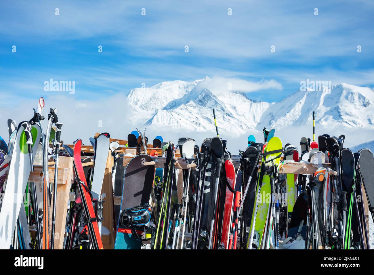 Many skis stand on alpine resort over mountain summits Stock Photo - Alamy