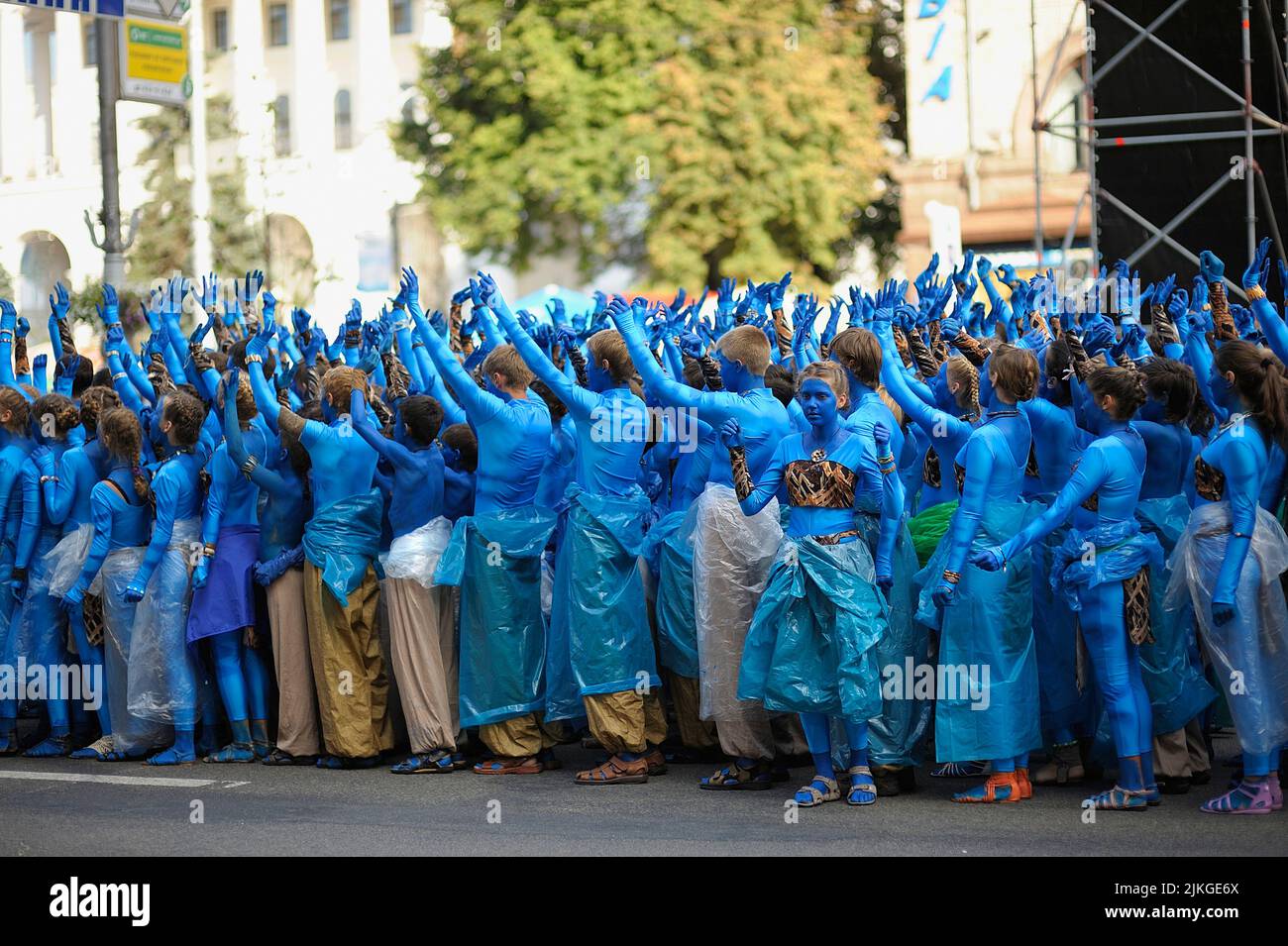 Group of young girls and boys coloured in blue like Avatars standing in ...