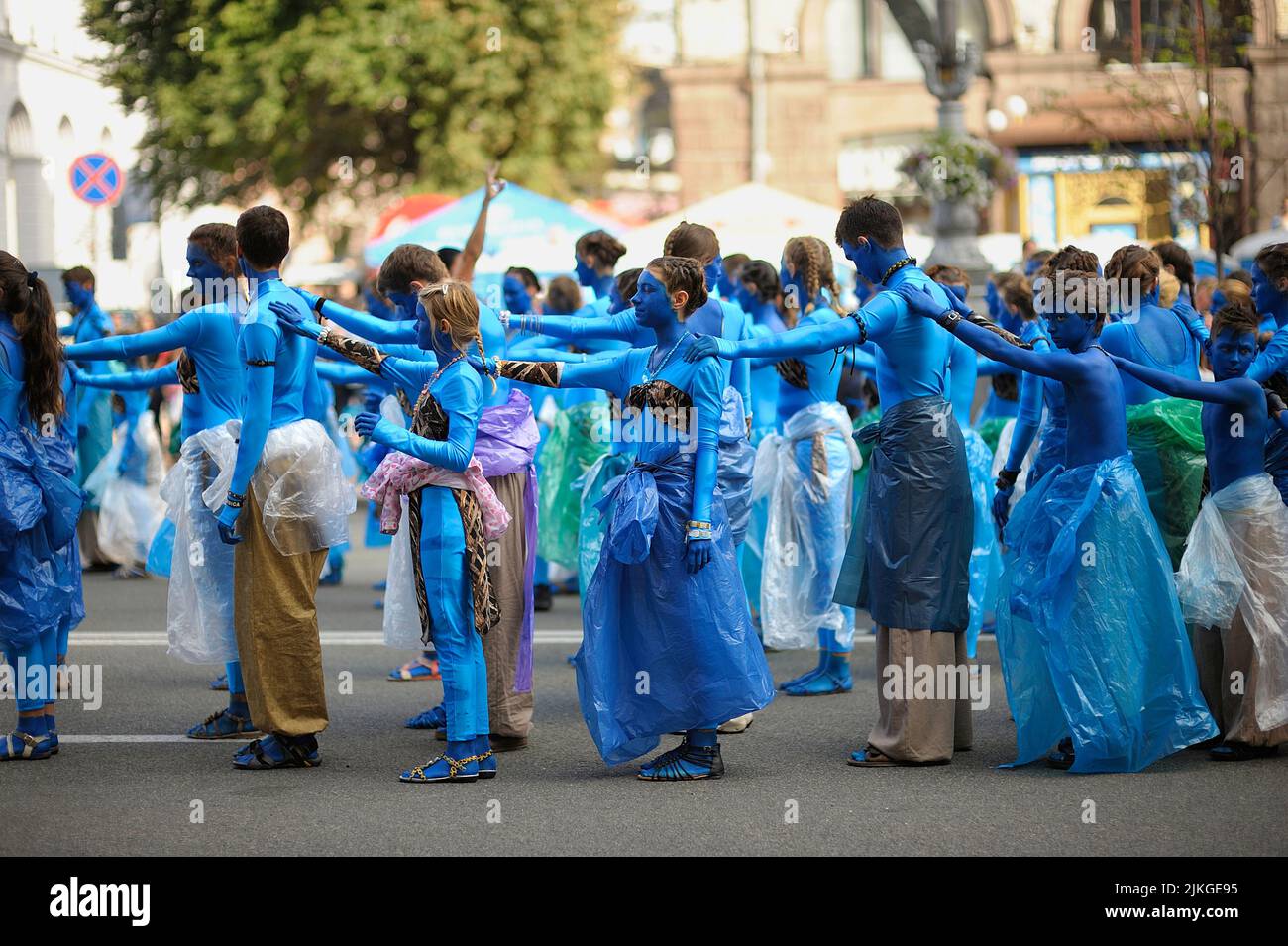Group of young girls and boys coloured in blue like Avatars standing in ...