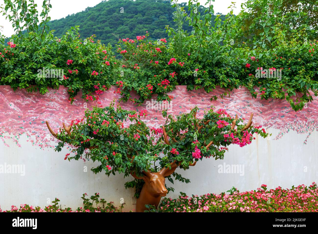 Romantic flower sika deer head and antlers statue in the garden Stock ...