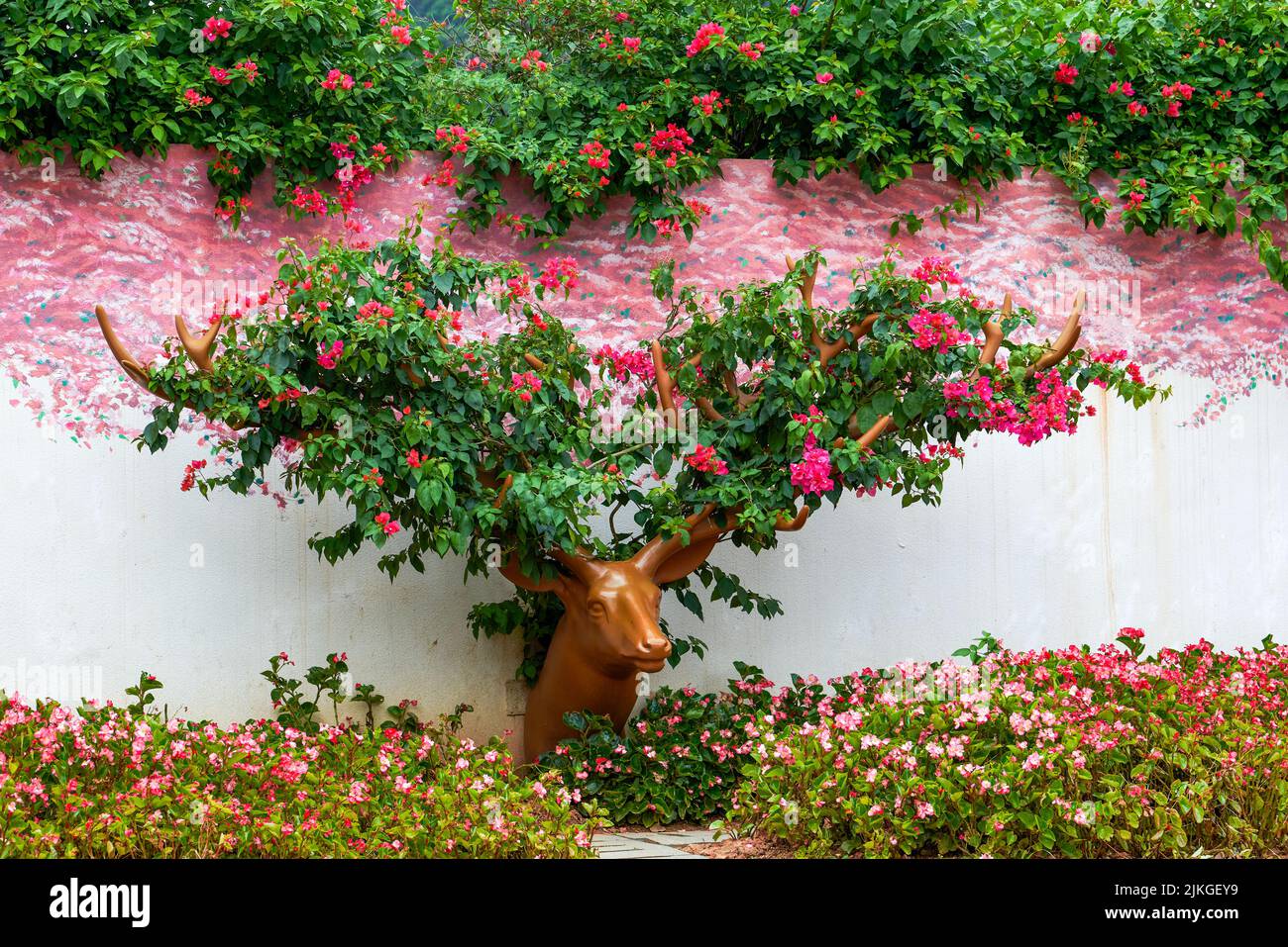 Romantic flower sika deer head and antlers statue in the garden Stock ...