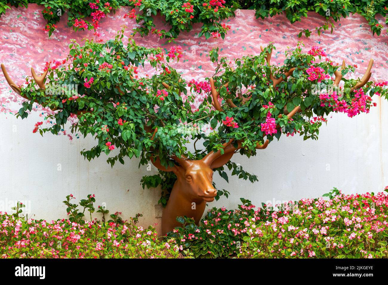 Romantic flower sika deer head and antlers statue in the garden Stock ...