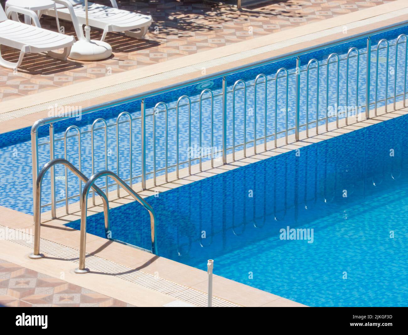 Pool filled with clear purified water. Handrails for entering Stock ...