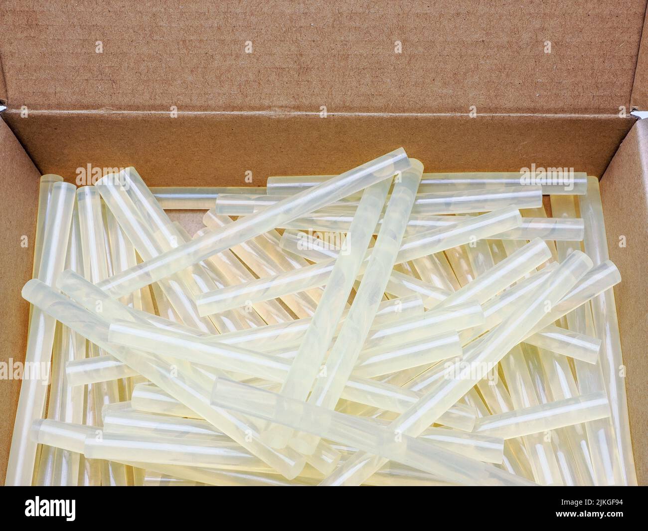 close up of a cardboard box of hot glue gun rods sticks Stock Photo - Alamy