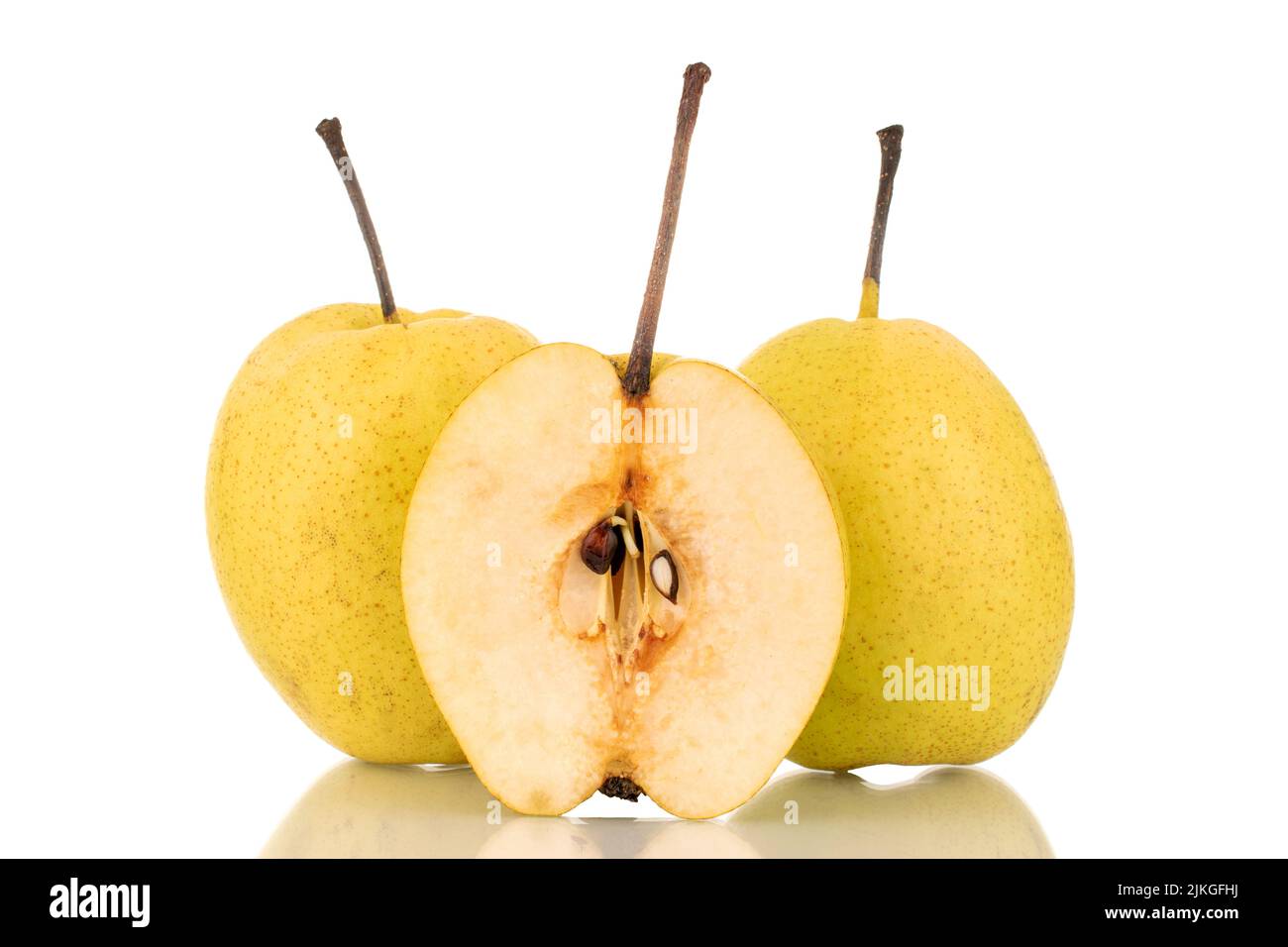 One half and two whole juicy yellow pears, close-up, isolated on a ...